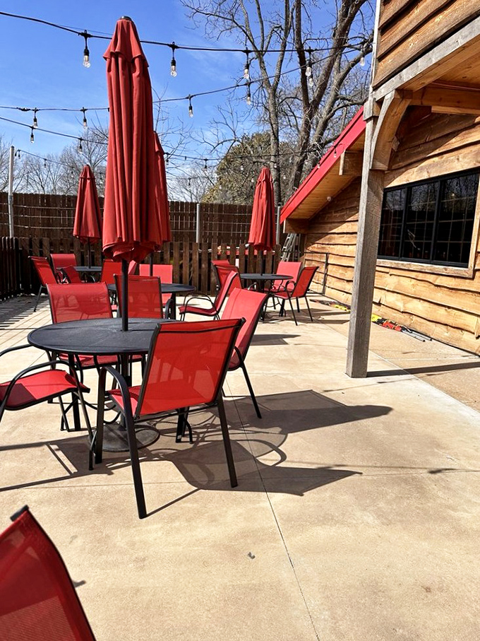 The outdoor patio with its bright red chairs stands ready for those perfect Arkansas evenings when eating indoors seems like missing the point.