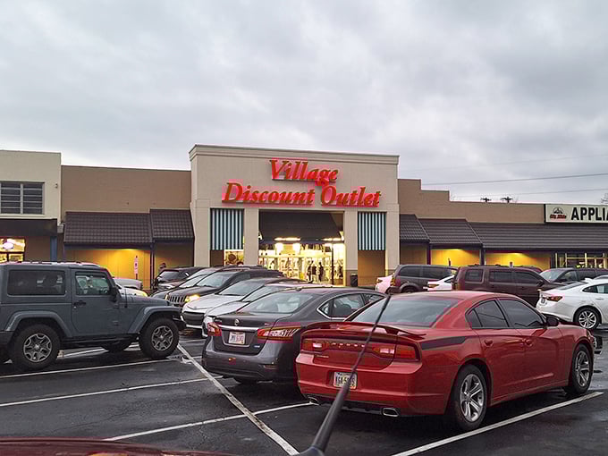 The Village Discount Outlet stands proud against a dramatic sky. Behind those doors lies a universe of possibilities where one person's past becomes another's future. 