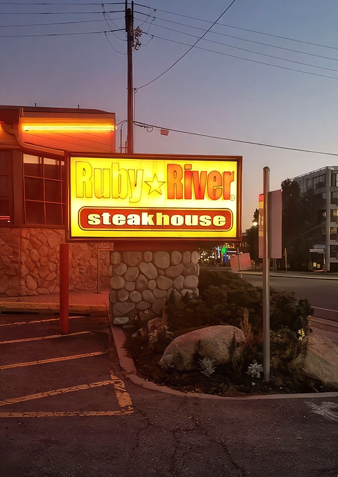 As evening falls, Ruby River's exterior glows with promise&mdash;like a lighthouse guiding hungry travelers to a safe harbor of excellent steaks.