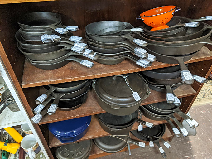 Cast iron paradise! Decades of perfectly seasoned skillets and Dutch ovens stand ready to transfer their culinary wisdom to your kitchen creations.