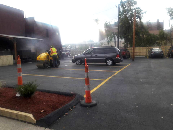 Even the parking lot tells a story—freshly painted lines and traffic cones suggesting this place is popular enough to need crowd control. Good barbecue creates its own traffic patterns.