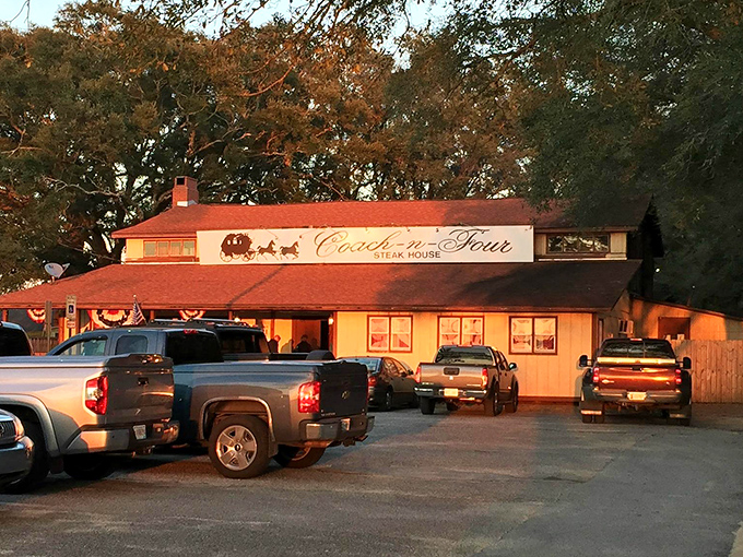 As sunset bathes the Coach-n-Four in golden light, trucks line up like faithful pilgrims at a shrine to perfectly cooked beef.