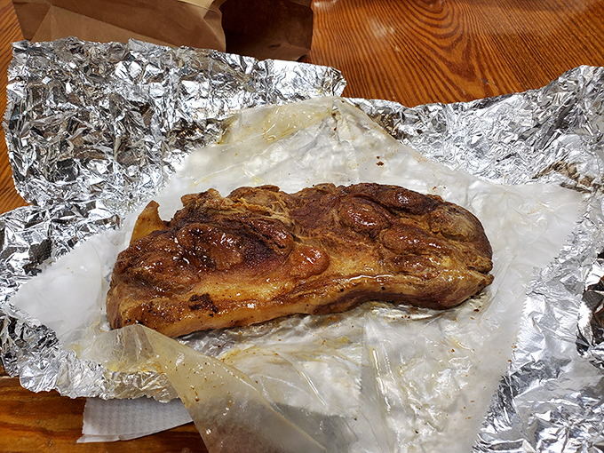 A pork chop that's lived a purposeful life, now fulfilling its destiny on a bed of aluminum foil. Simplicity at its most delicious.