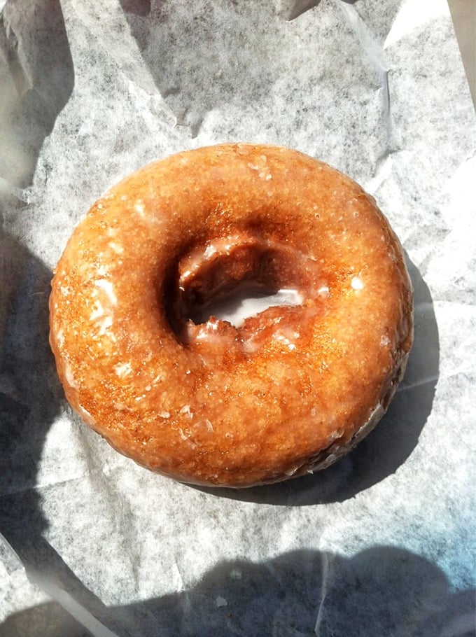 The humble glazed donut—proof that perfection doesn't need to be complicated, just perfectly executed with a golden crust and glossy finish.