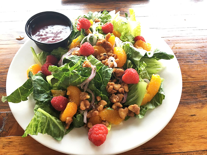 A salad that doesn't apologize for being healthy &ndash; it's too busy showing off with fresh berries, candied walnuts, and a raspberry vinaigrette worth bottling.