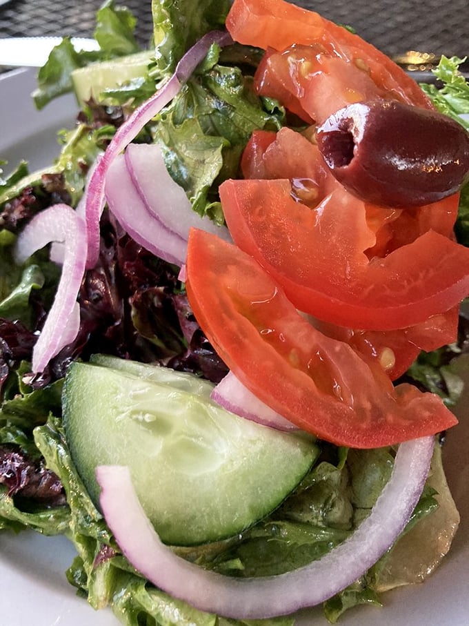 Even the salads deserve your attention here. Crisp greens, vibrant tomatoes, and purple onions prove The Wedge isn't just about the dough.