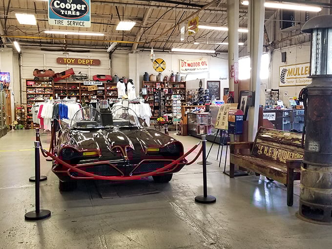 Holy automotive culture, Batman! The Batmobile takes center stage amid vintage signs and memorabilia&mdash;proof that cars and pop culture are inseparable.