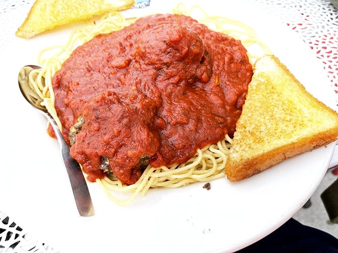 Spaghetti and meatballs with marinara so generous it's practically a red sea, flanked by golden toast islands&mdash;comfort food at its most comforting.
