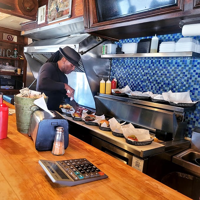 The maestro at work, crafting each burger with the focus of a surgeon and the soul of an artist. This isn't cooking&mdash;it's performance art.