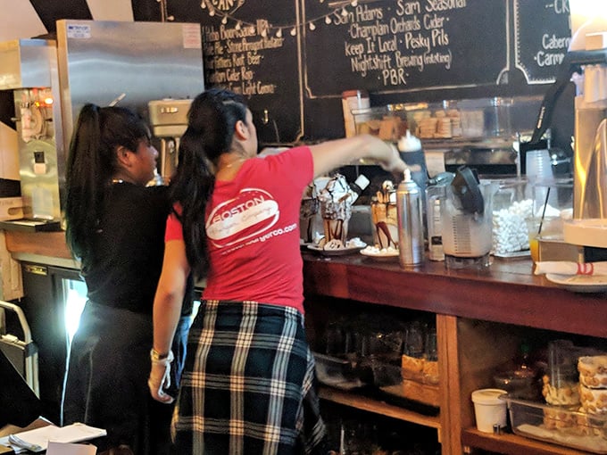 The shake architects at work, crafting towering dessert creations that make adults gasp like children on Christmas morning.