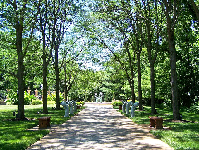 Tree-lined paths at the Precious Moments Chapel grounds invite contemplative strolls through gardens designed for reflection and serenity.