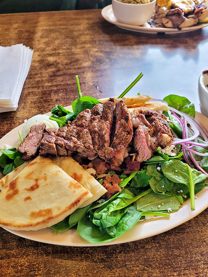 Who said salads can't be exciting? This steak-topped creation proves that vegetables are just a delivery system for more meat.