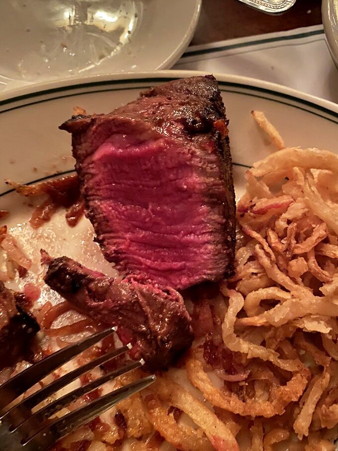 A perfectly medium-rare steak reveals its rosy interior. This is beef at its most honest&mdash;seasoned simply and cooked with respect.