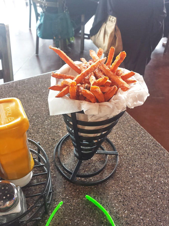 Sweet potato fries standing at attention in their metal cone, like orange soldiers ready to march straight into your heart.