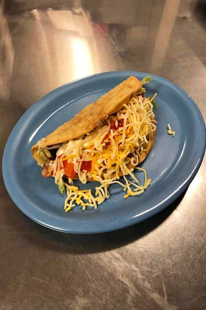 This enchilada plate isn't just dinner&mdash;it's artwork. Smothered in sauce and draped with sour cream, it's the kind of comfort food that makes bad days disappear.