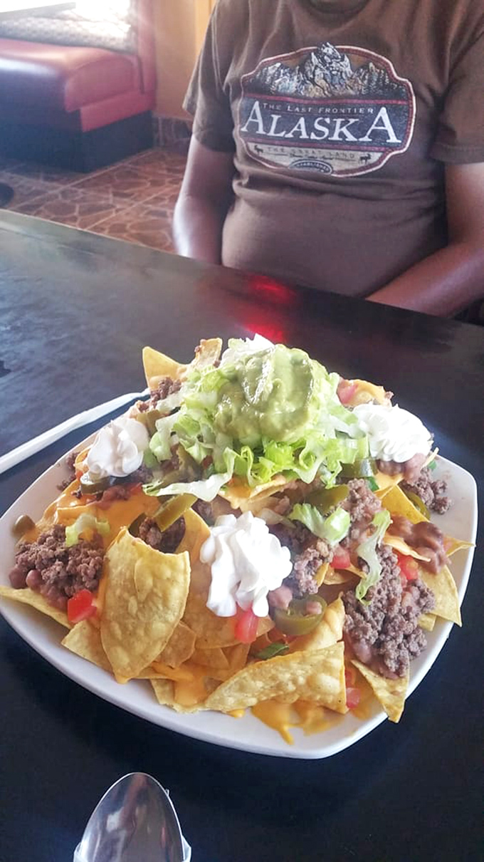Not just nachos &ndash; a mountain range of flavor with peaks of guacamole, valleys of melted cheese, and enough toppings to require a topographical map.