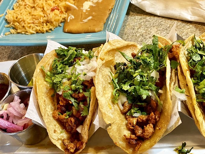 Tacos al pastor that respect tradition: simple corn tortillas, marinated pork, fresh cilantro, and onion. No unnecessary frills, just pure taco perfection.
