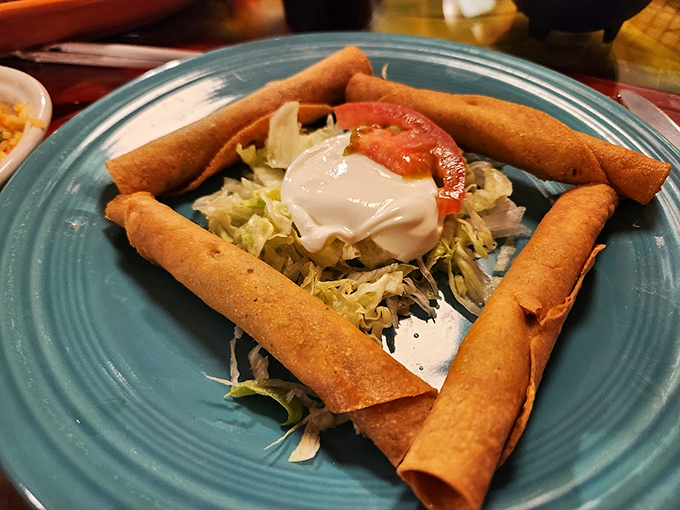 These taquitos aren't just rolled tortillas&mdash;they're crispy cylinders of joy standing guard around a fresh salad center. Crunchy sentinels of satisfaction.