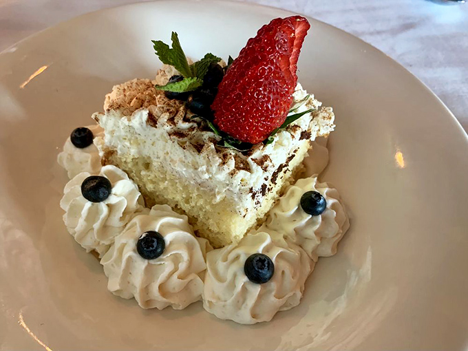 This Tres Leches cake, crowned with a strawberry and surrounded by whipped cream florets, isn't dessert&mdash;it's the grand finale your meal deserves.