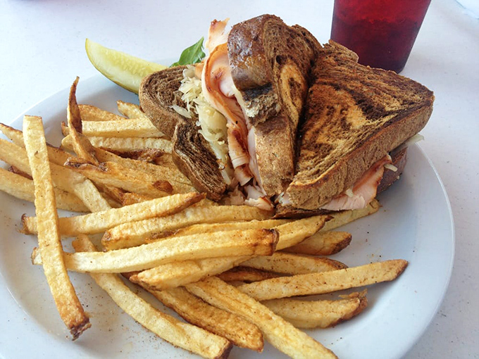 The humble sandwich elevated to art form &ndash; crispy fries standing at attention beside a marble rye masterpiece that's anything but ordinary.