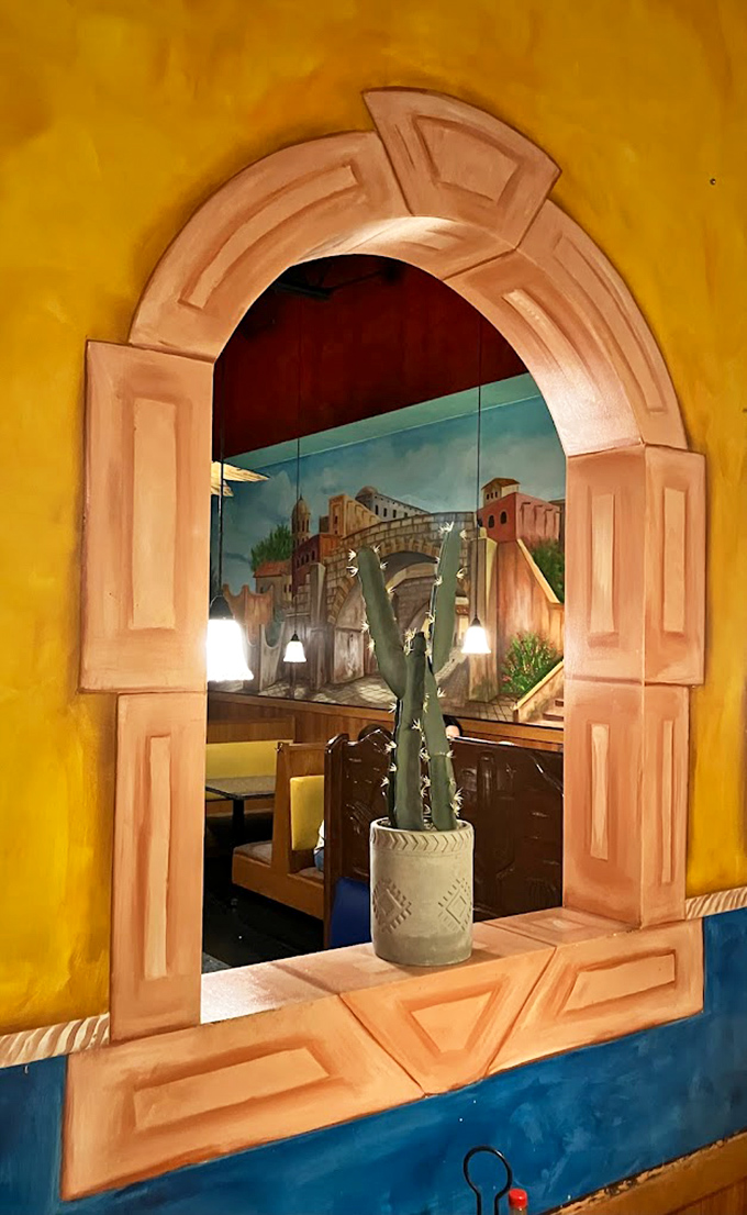 Peek through this painted archway and glimpse another dining section. El Burrito Loco's interior is like a Russian nesting doll of Mexican charm.