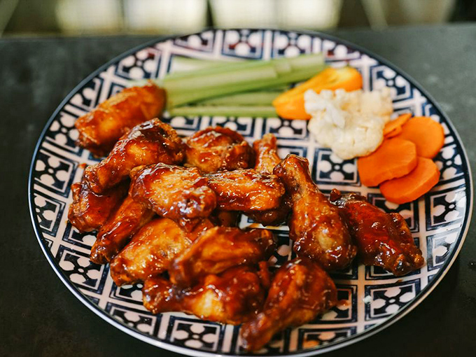 Wings that don't just satisfy hunger—they solve problems. Notice how they're arranged like they're posing for their own delicious album cover.