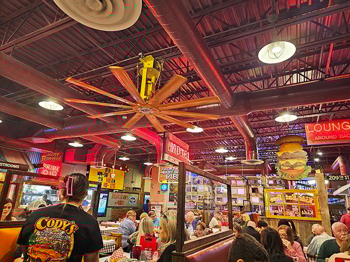 When ceiling fans look like they belong in an airplane hangar, you know you're somewhere special. The buzzing atmosphere matches the dramatic industrial design.