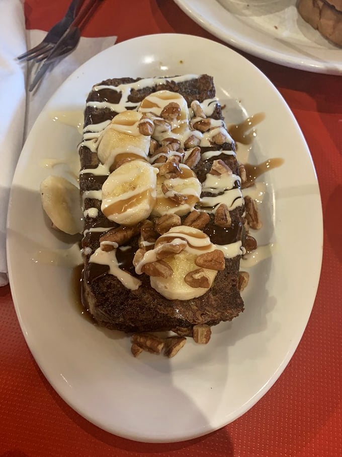 Banana bread French toast that makes regular French toast question its life choices. With cream, nuts, and what appears to be caramel, it's dessert masquerading as breakfast &ndash; and we're not complaining.