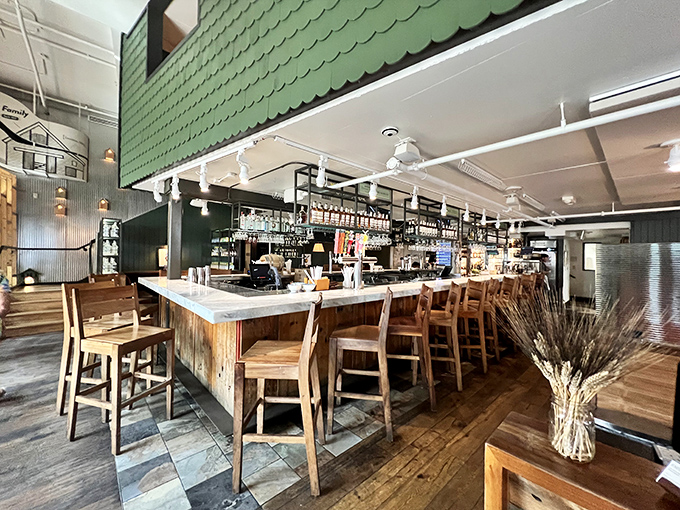 The bar area marries farmhouse aesthetics with urban sophistication. Wheat stalks in a vase remind you of the restaurant's commitment to agricultural roots.