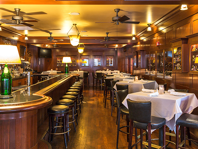 The bar area offers the full menu with a side of people-watching, perfect for solo diners or those who prefer their steak with a dash of casual atmosphere.