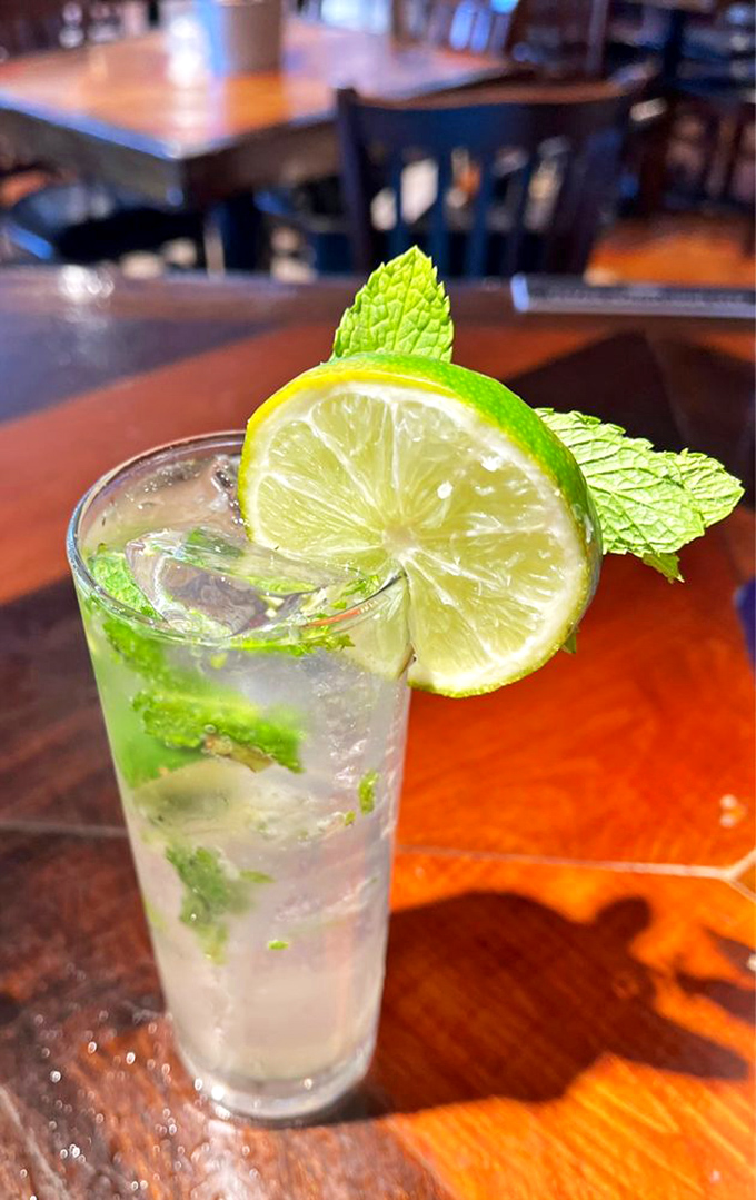 A refreshing mojito garnished with lime and mint stands ready to cool you down after a day of Florida heat. The perfect liquid sidekick to Ford's hearty fare.