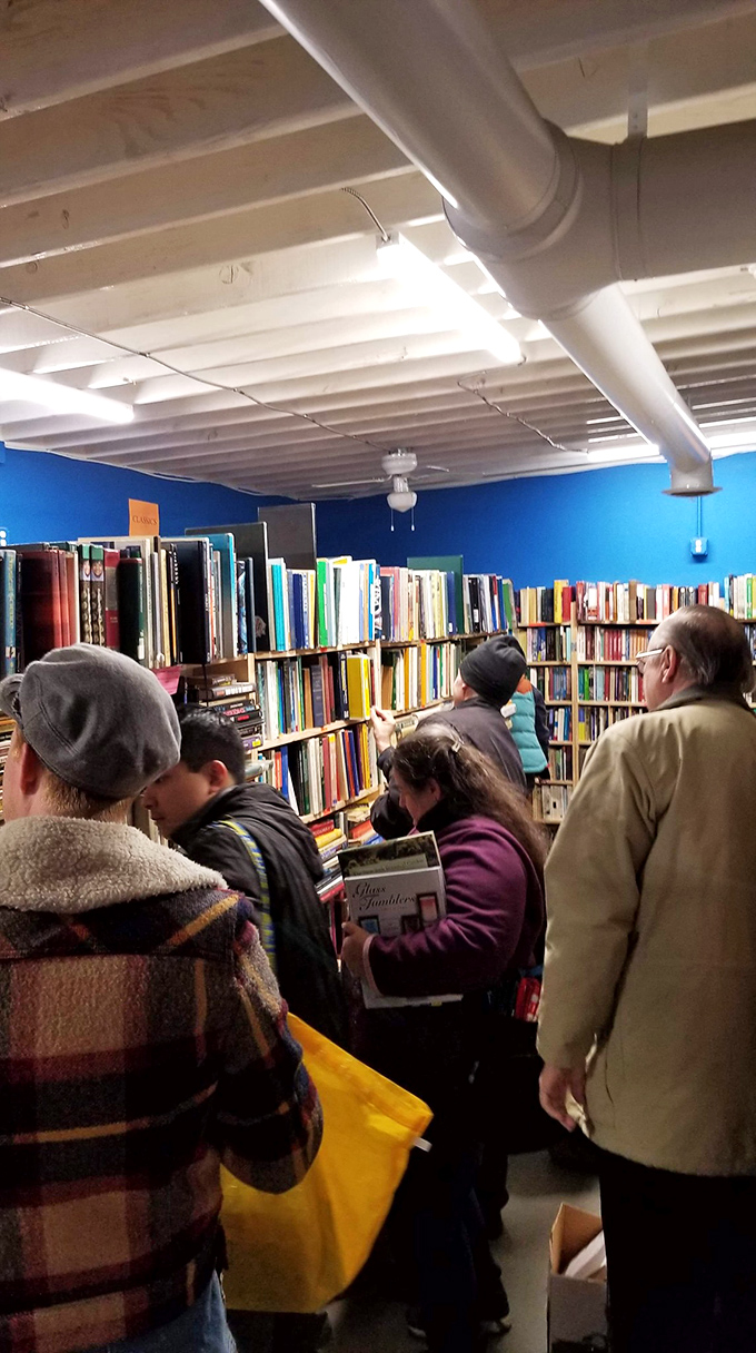 In the blue room, kindred spirits gather among the stacks. Strangers united by the universal language of literature and free books.