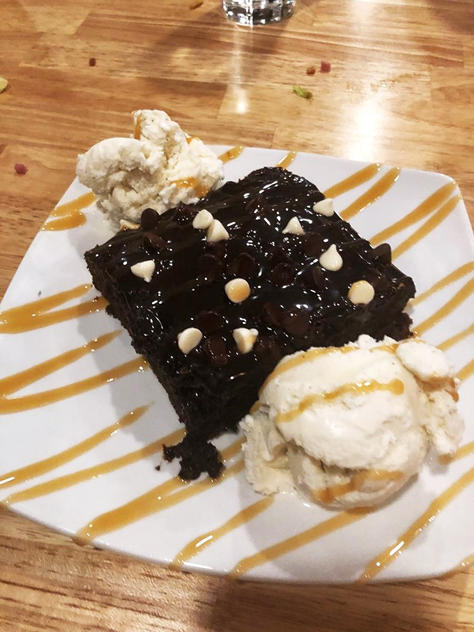 The grand finale &ndash; a chocolate brownie flanked by vanilla ice cream sentries, drizzled with caramel that's basically saying, "You made the right choice coming here."