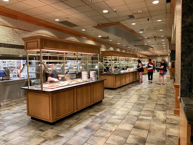 Buffet warriors advance with purpose, plotting strategies for optimal plate coverage while maintaining structural integrity. It's an art form, really.