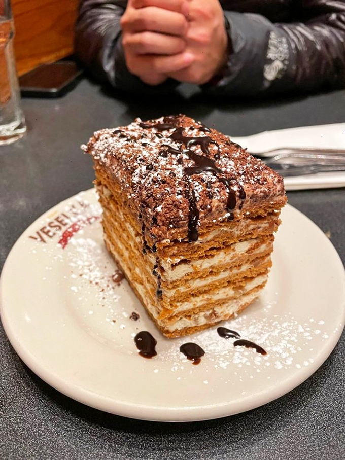 The honey cake stands tall and proud, layer upon chocolatey layer of sweet Eastern European tradition that demands to be savored one fork-full at a time.