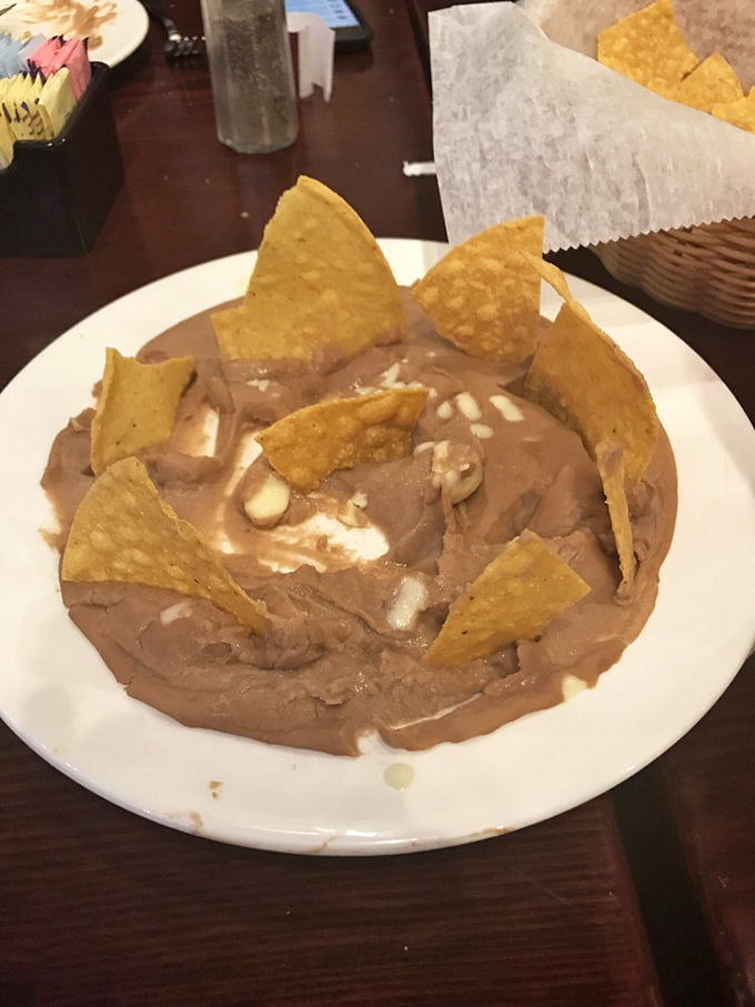 Bean dip with strategically placed chips&mdash;like a delicious game of Jenga where everyone wins, especially your appetite.