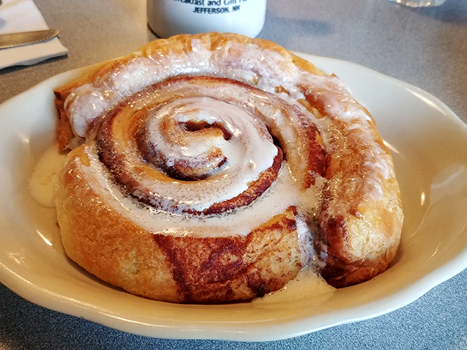 This cinnamon roll isn't just breakfast&mdash;it's edible architecture. The spiral design leads your eyes to the center where all that gooey goodness awaits.