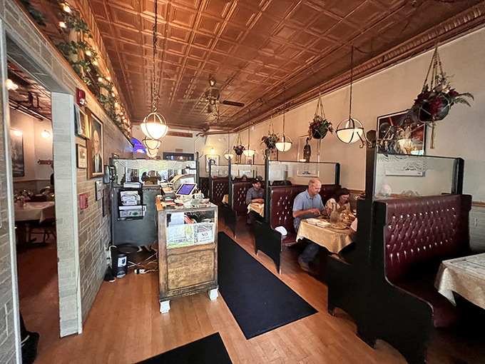 The dining room's vintage ceiling and cozy booths create an atmosphere where time slows down. No one rushes you through butter-soaked perfection here.