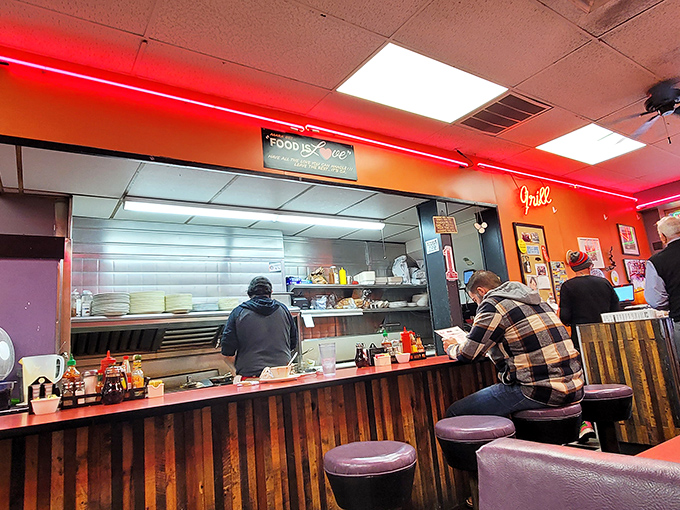 Where the magic happens: The counter where coffee mugs are always full and breakfast dreams come true under the watchful glow of red neon.