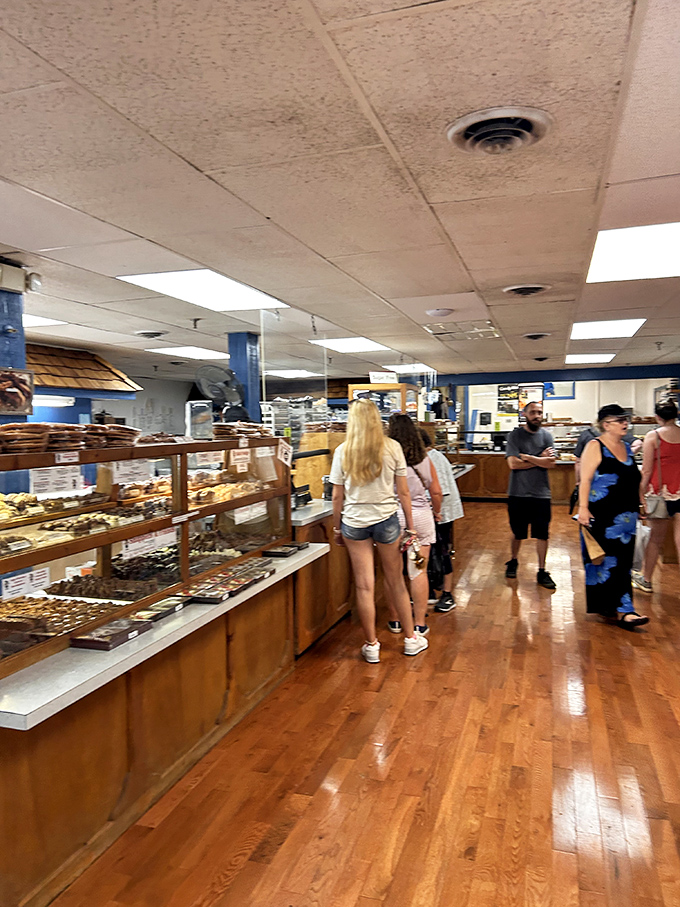 Pilgrims on the path to sweetness. These customers navigate the wooden-floored paradise with the focused determination of chocolate seekers on a mission.
