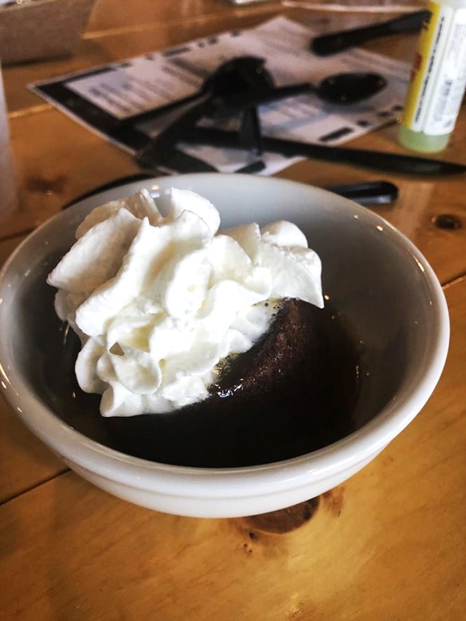 Sticky toffee pudding crowned with cream &ndash; the kind of dessert that makes you consider ordering a second before finishing the first.