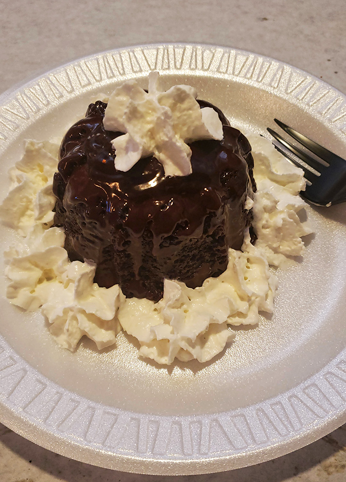 A chocolate dessert surrounded by whipped cream islands&mdash;because after conquering the sea, your sweet tooth deserves its own adventure.