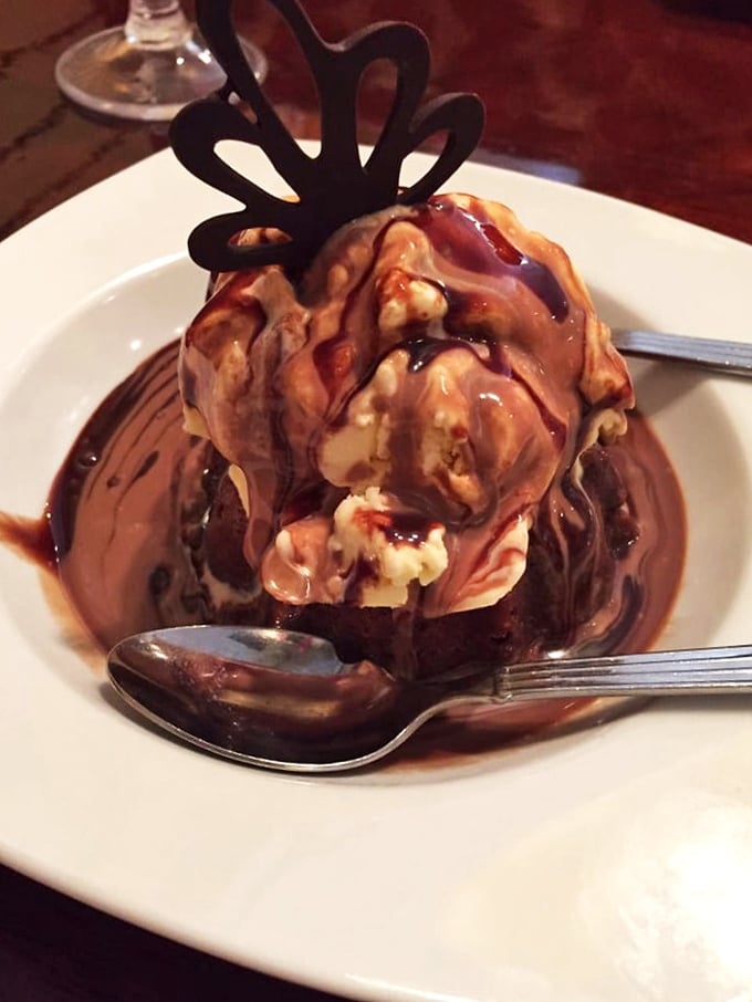 Ice cream melting into warm brownie creates a dessert solar system. That chocolate decoration isn't just garnish&mdash;it's the crown jewel of indulgence.