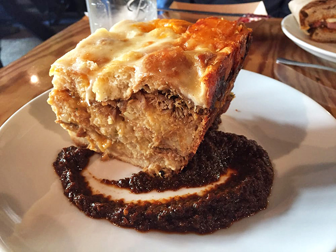 Natural light streams through windows illuminating simple wooden tables where magic happens. This isn't just a restaurant&mdash;it's where food memories are born.