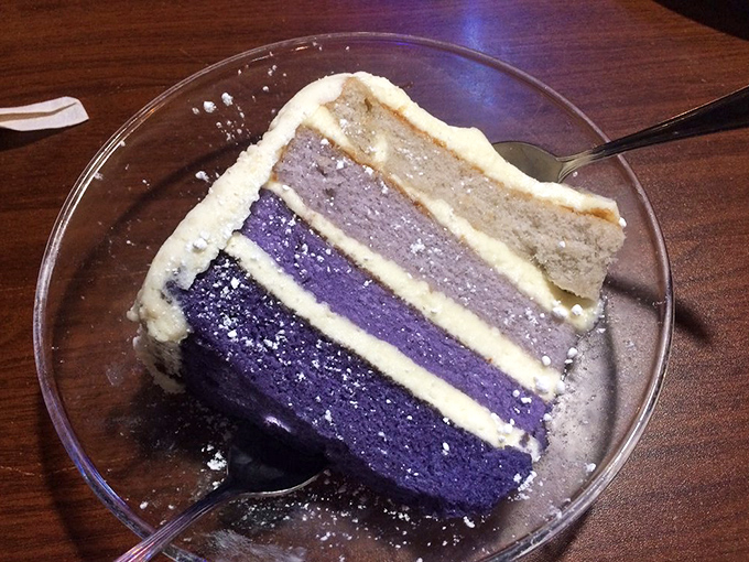 A slice of purple-hued cake that's as unexpected as finding a unicorn at a rodeo, but twice as delightful.