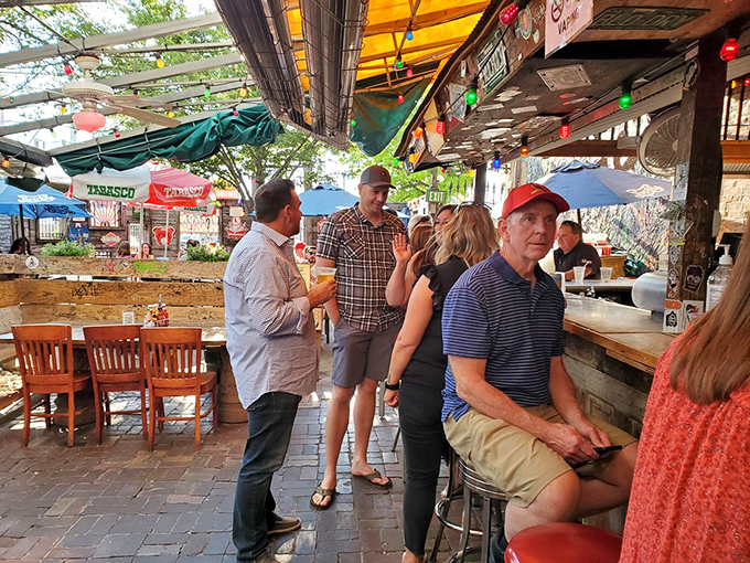 The outdoor bar area buzzes with the energy of people who came as strangers but will likely leave as friends.