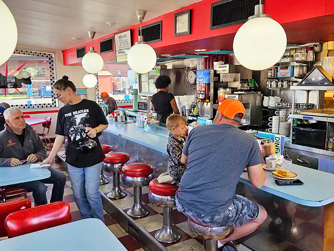 Where magic happens—cooks orchestrating breakfast symphonies while diners of all ages gather at the counter to witness the choreographed dance of diner life.