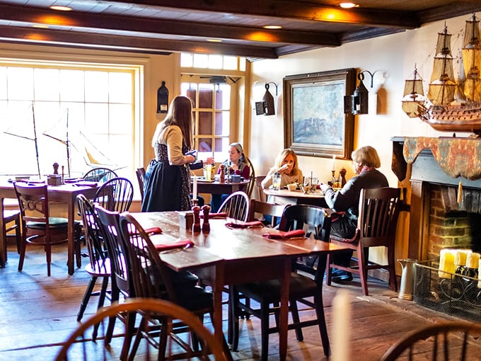 The dining room buzzes with happy conversation as servers in period-inspired attire deliver plates that bridge the gap between colonial history and modern appetite.