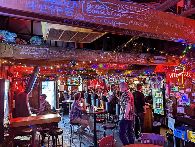 In the red glow of Reel M Inn, Portland's diverse crowd gathers at the altar of fried chicken, proving some pleasures truly are universal.