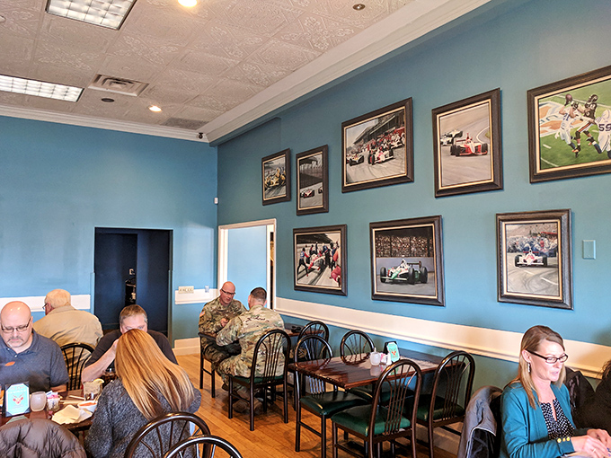 The dining room buzzes with the happy sounds of people making memories over meals. Those racing photos on the wall are just getting started.